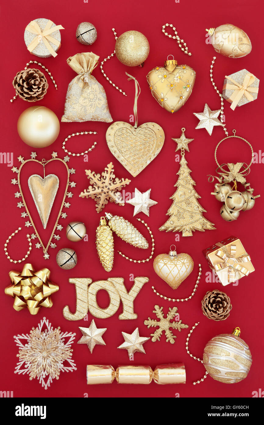 Gold christmas symbols with tree decorations and baubles over red ...