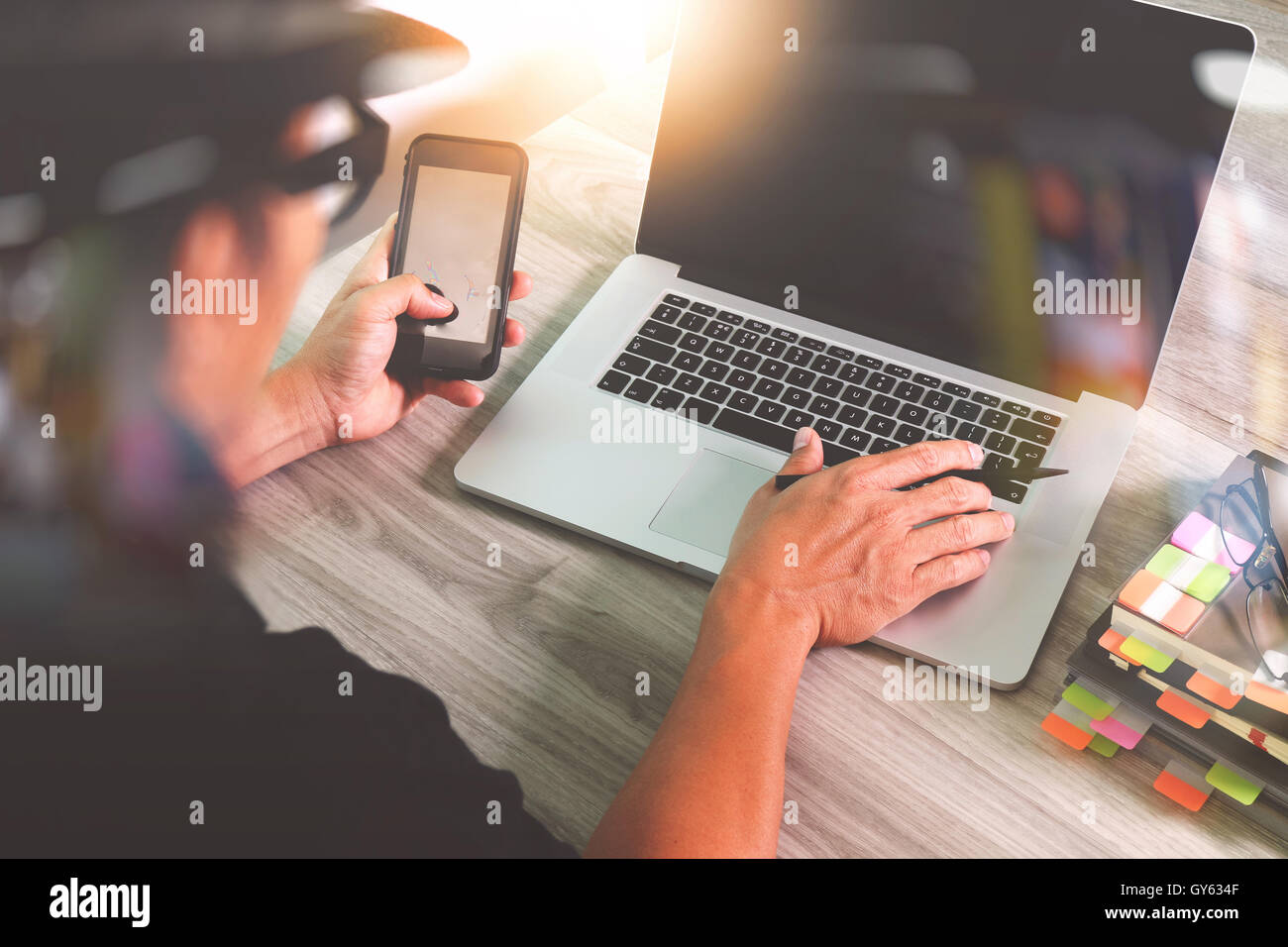 designer hand attending video conference with laptop computer and smart ...