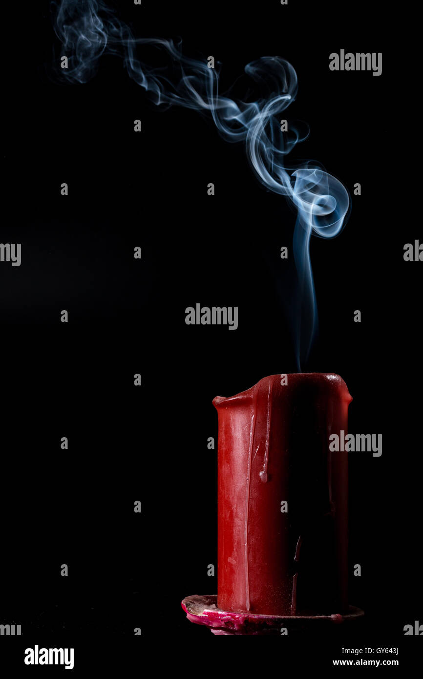 smoke goes up from the extinct red candle Stock Photo - Alamy