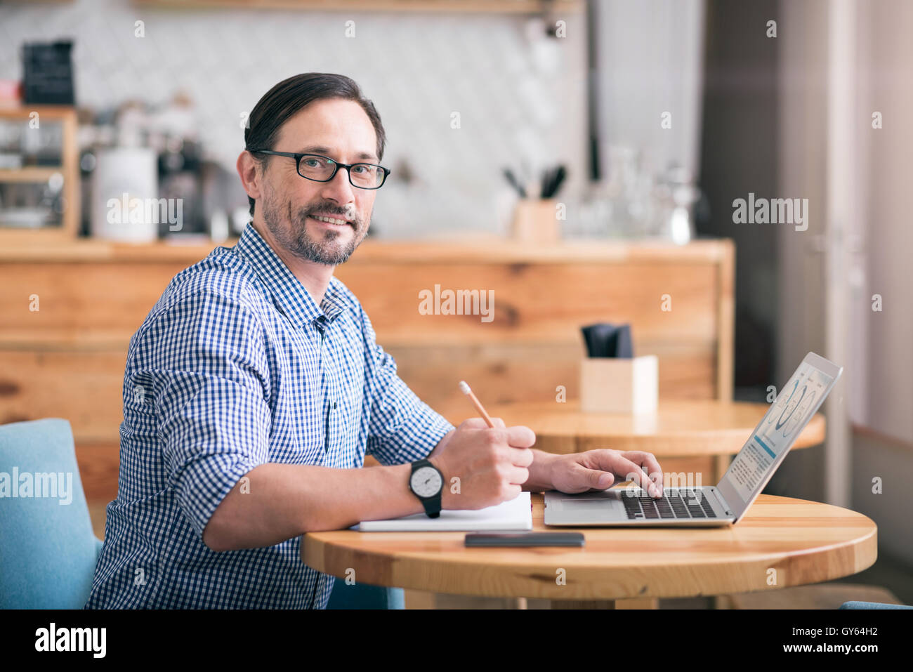 Handsome man making notes Stock Photo - Alamy