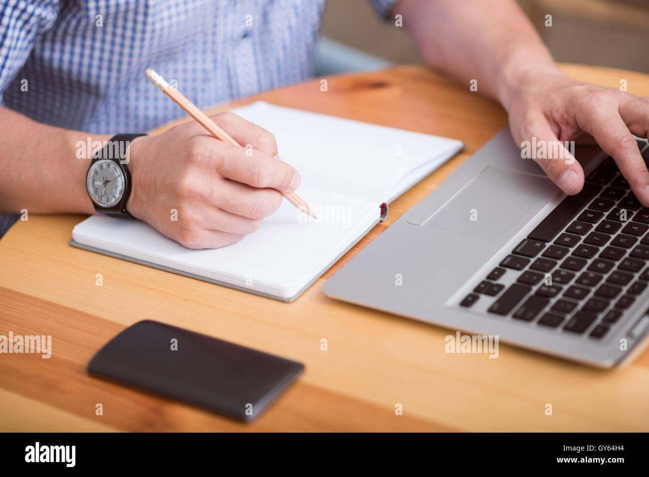 Nice man writing something down Stock Photo - Alamy