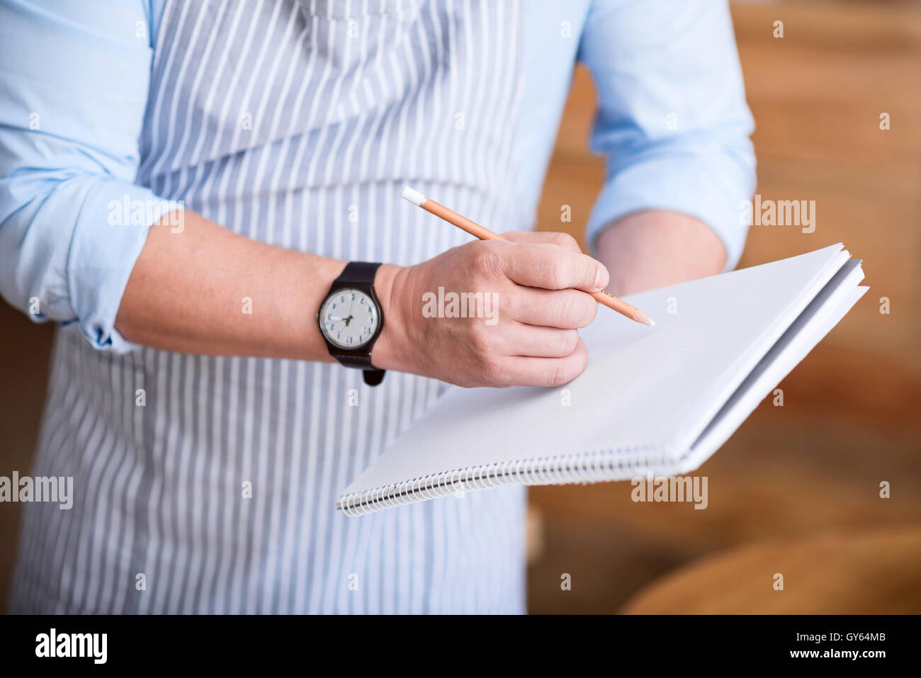Nice man writing something down Stock Photo - Alamy