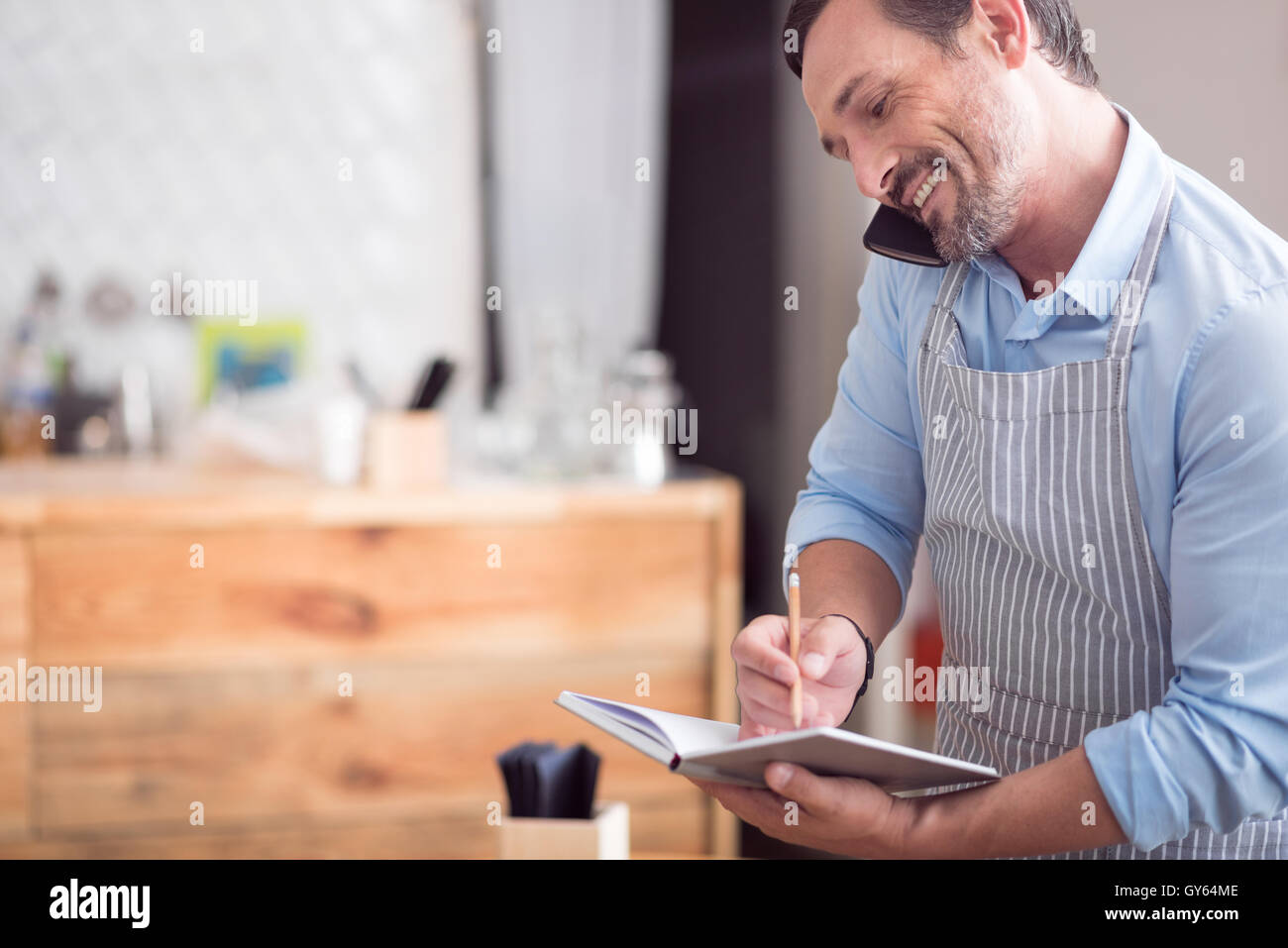 Busy man writing something down Stock Photo - Alamy