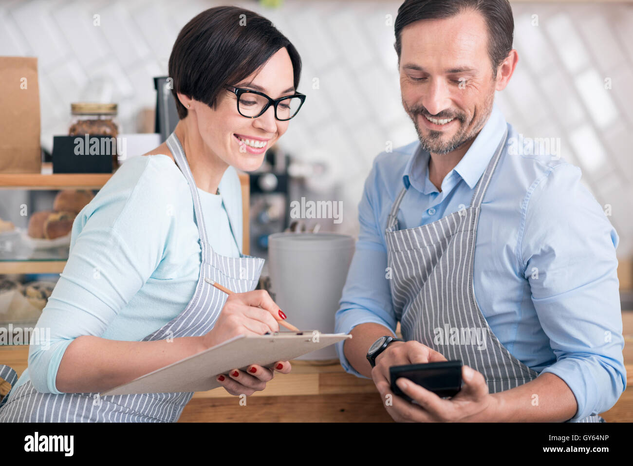 Two waiters communicating in cafe Stock Photo - Alamy