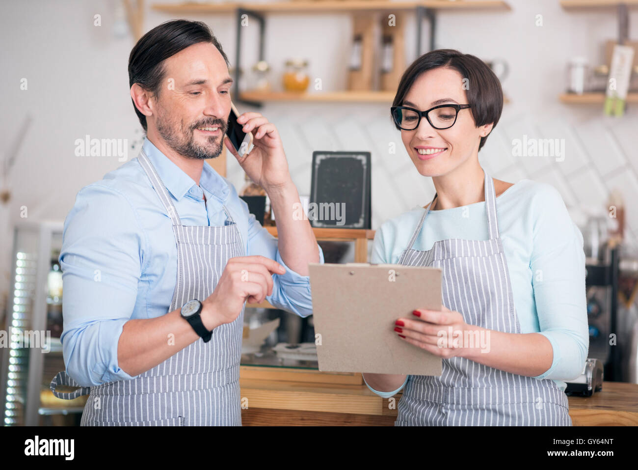Two workers communicating in cafe Stock Photo - Alamy