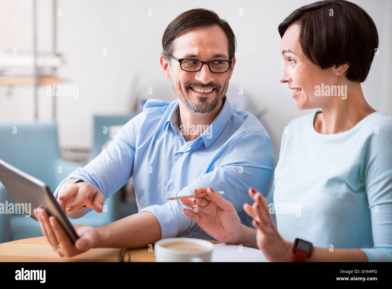 Friendly coworkers working together Stock Photo - Alamy