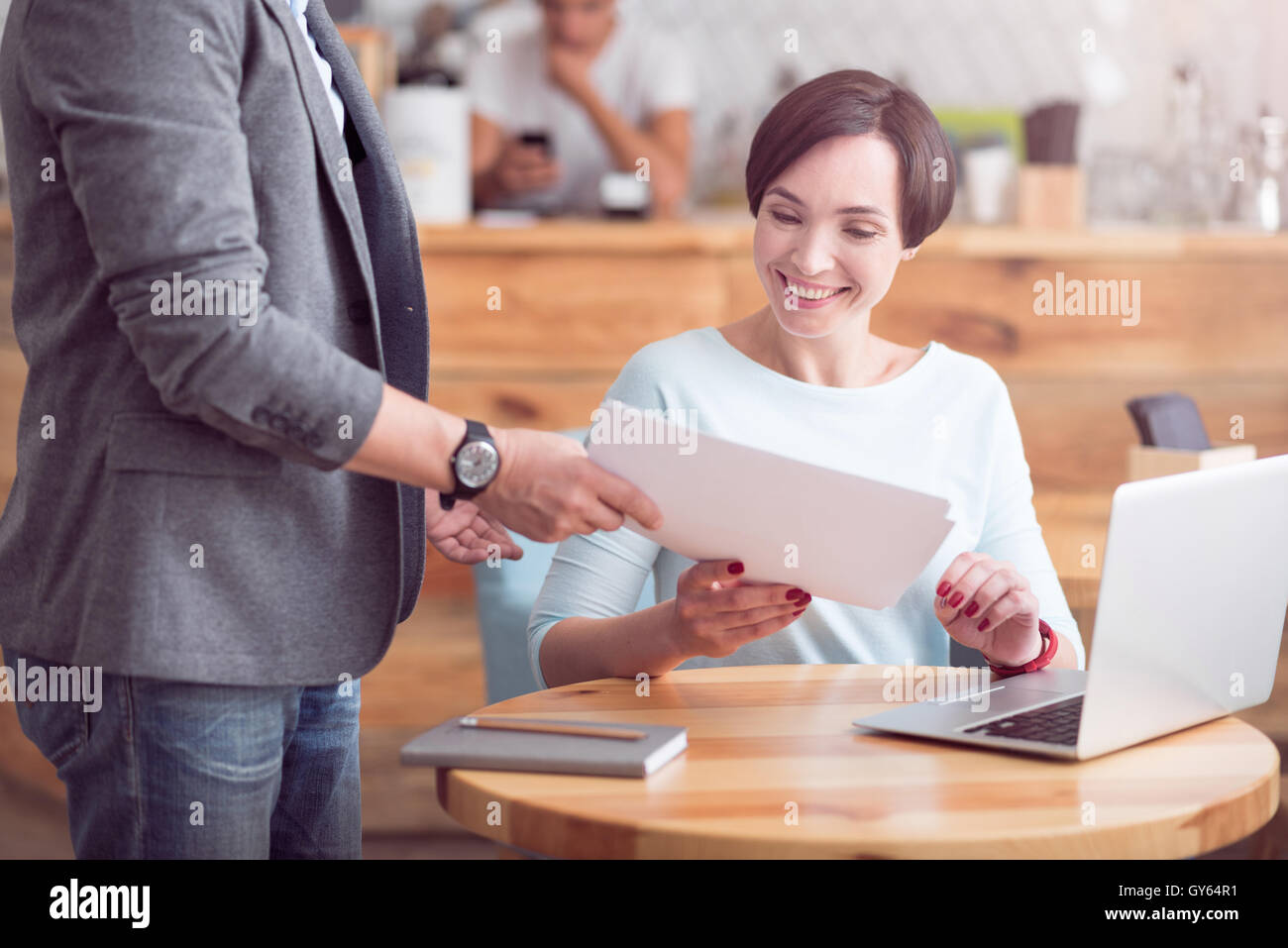 Attractive coworkers cooperating together Stock Photo - Alamy