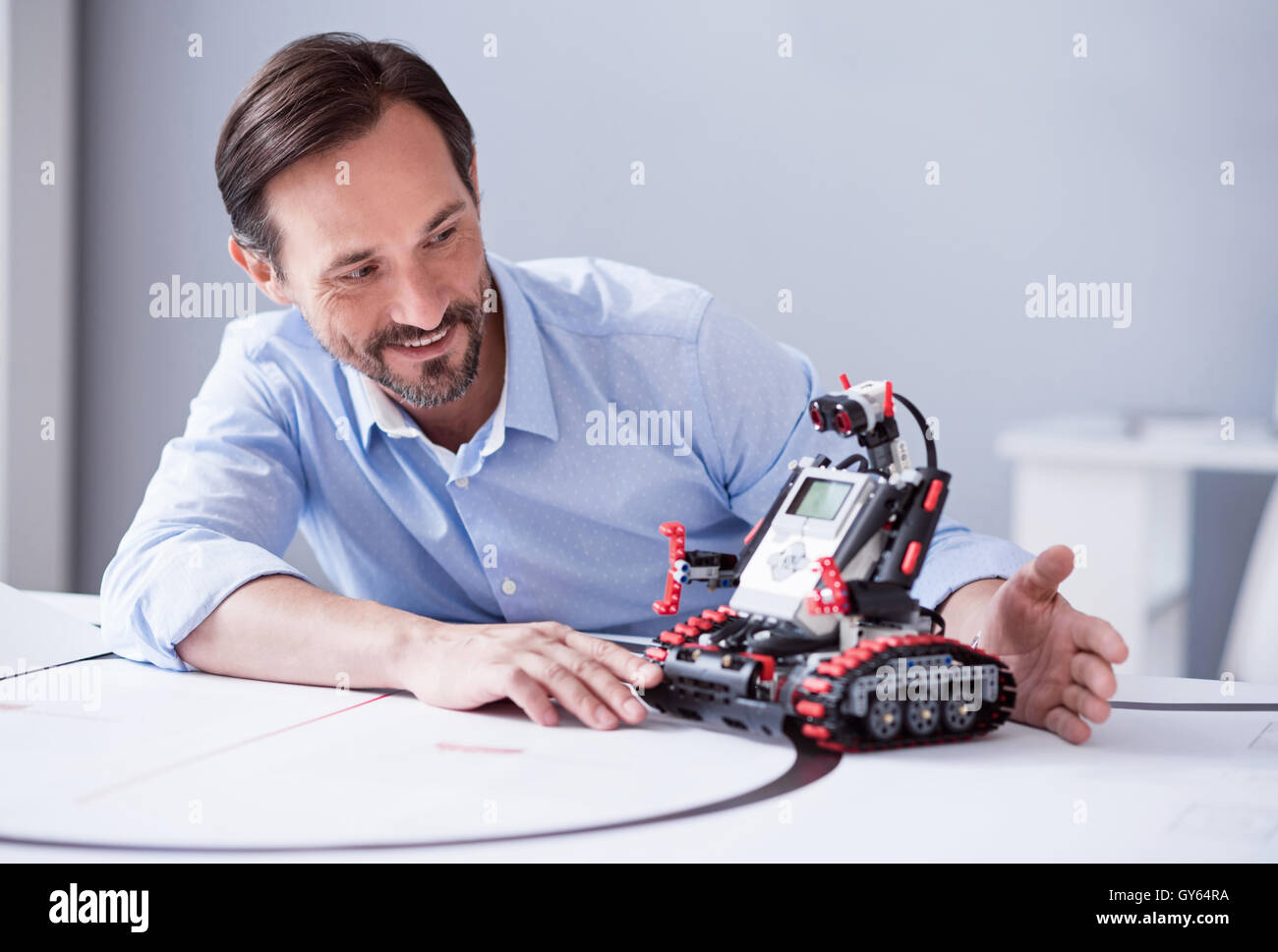 Handsome man with a beard using robot Stock Photo - Alamy