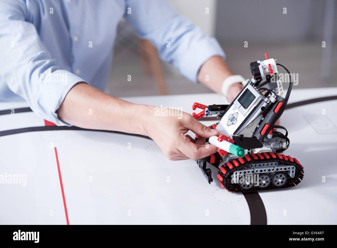 Small humanlike robot holding green marker Stock Photo - Alamy Small humanlike robot holding green marker Stock Photo - Alamy
