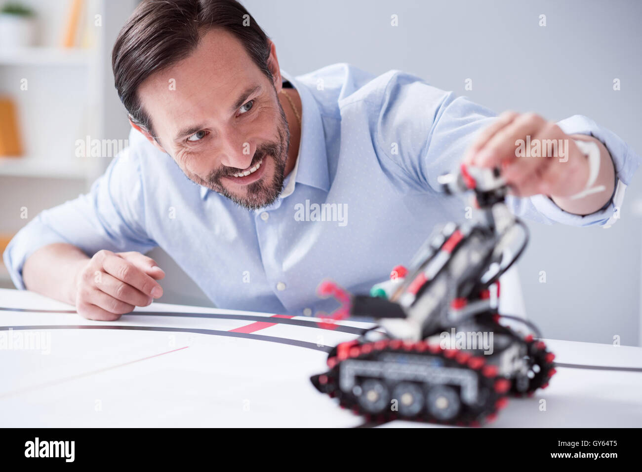 Handsome smiling scientist enjoys his invention Stock Photo - Alamy