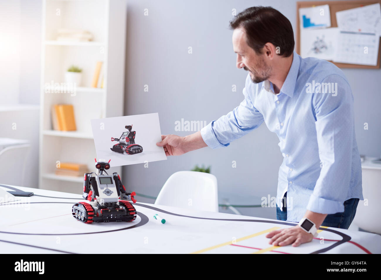 Man holding a picture of his invention Stock Photo - Alamy