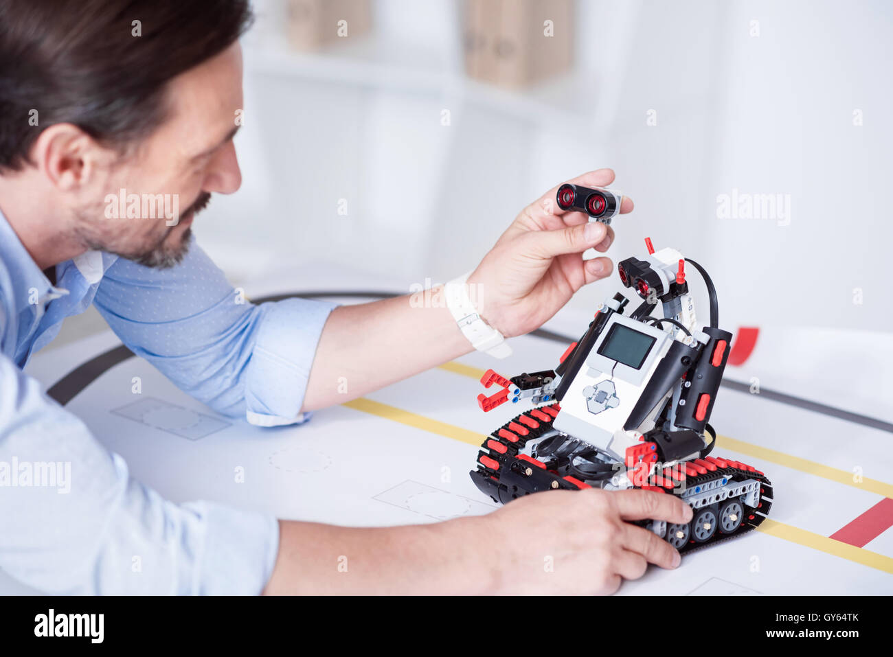 Man making change in construction of machine Stock Photo - Alamy
