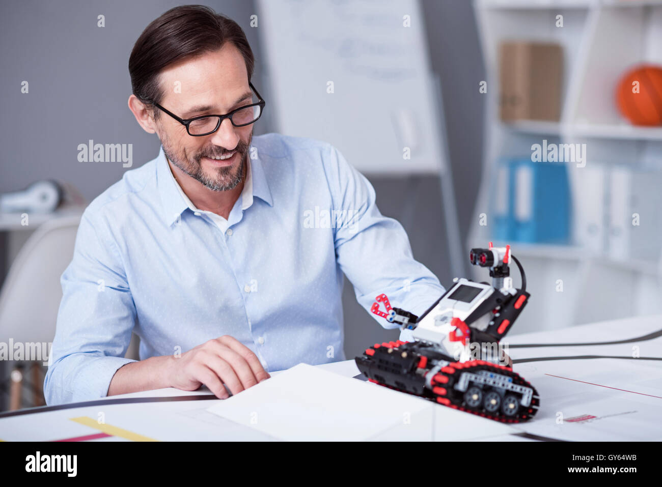 Old man being exited to test a little robot Stock Photo - Alamy