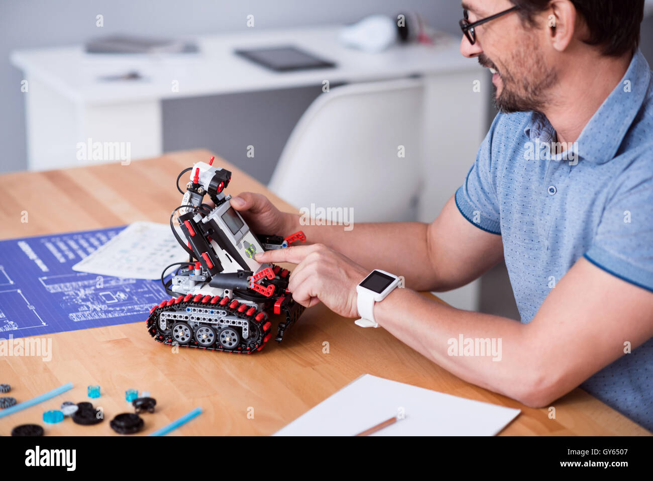Cheerful man using robot Stock Photo - Alamy