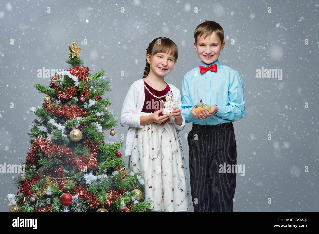 Children near christmas tree Stock Photo - Alamy
