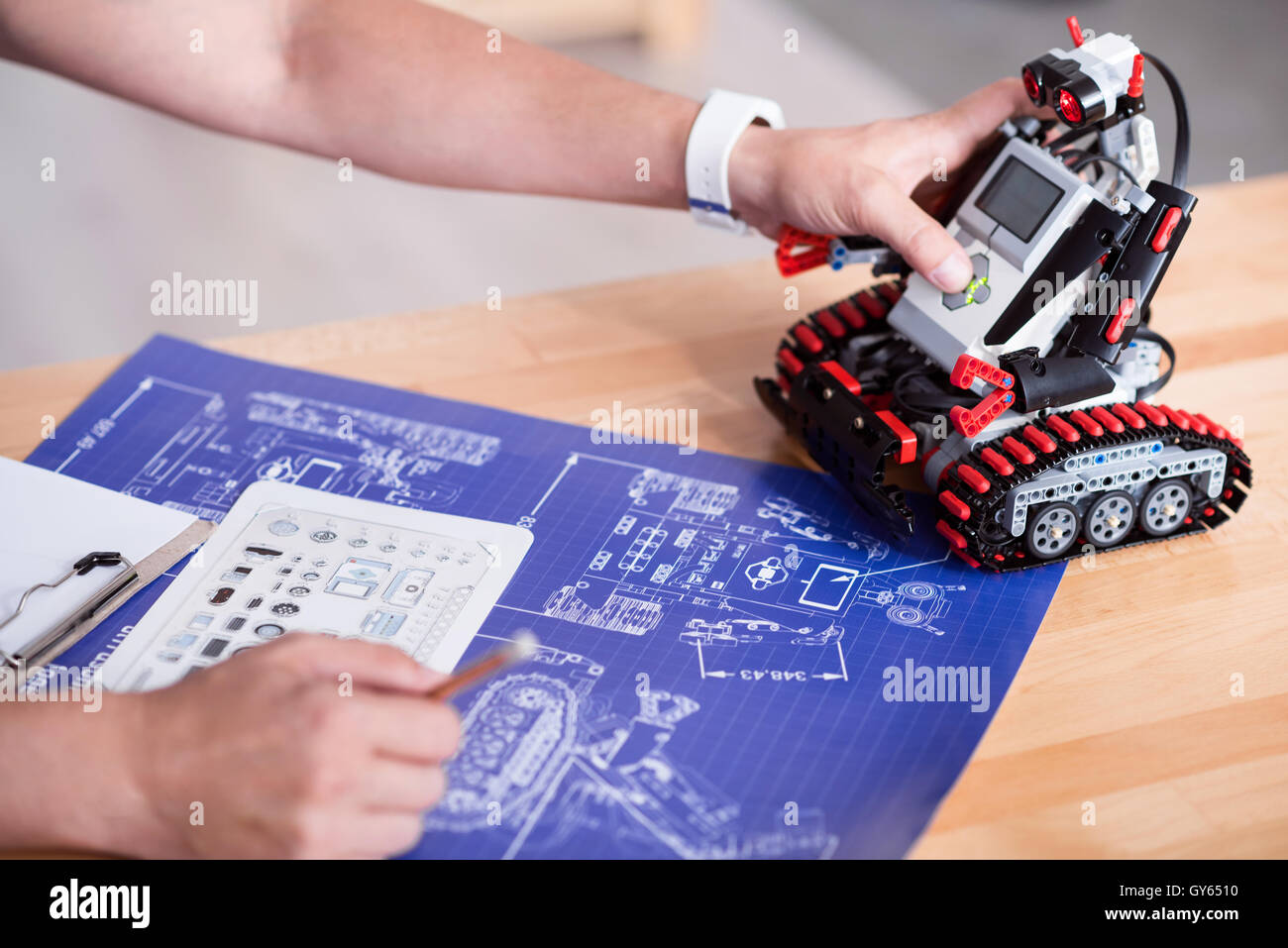 Pleasant professional engineer testing robot Stock Photo - Alamy