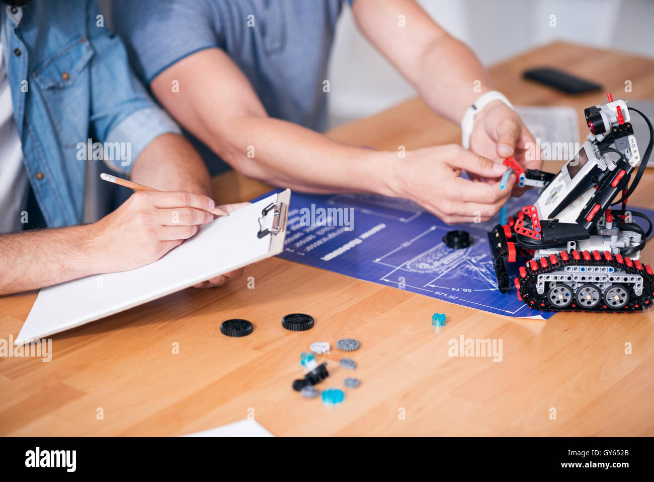 Professional colleague testing robot Stock Photo - Alamy