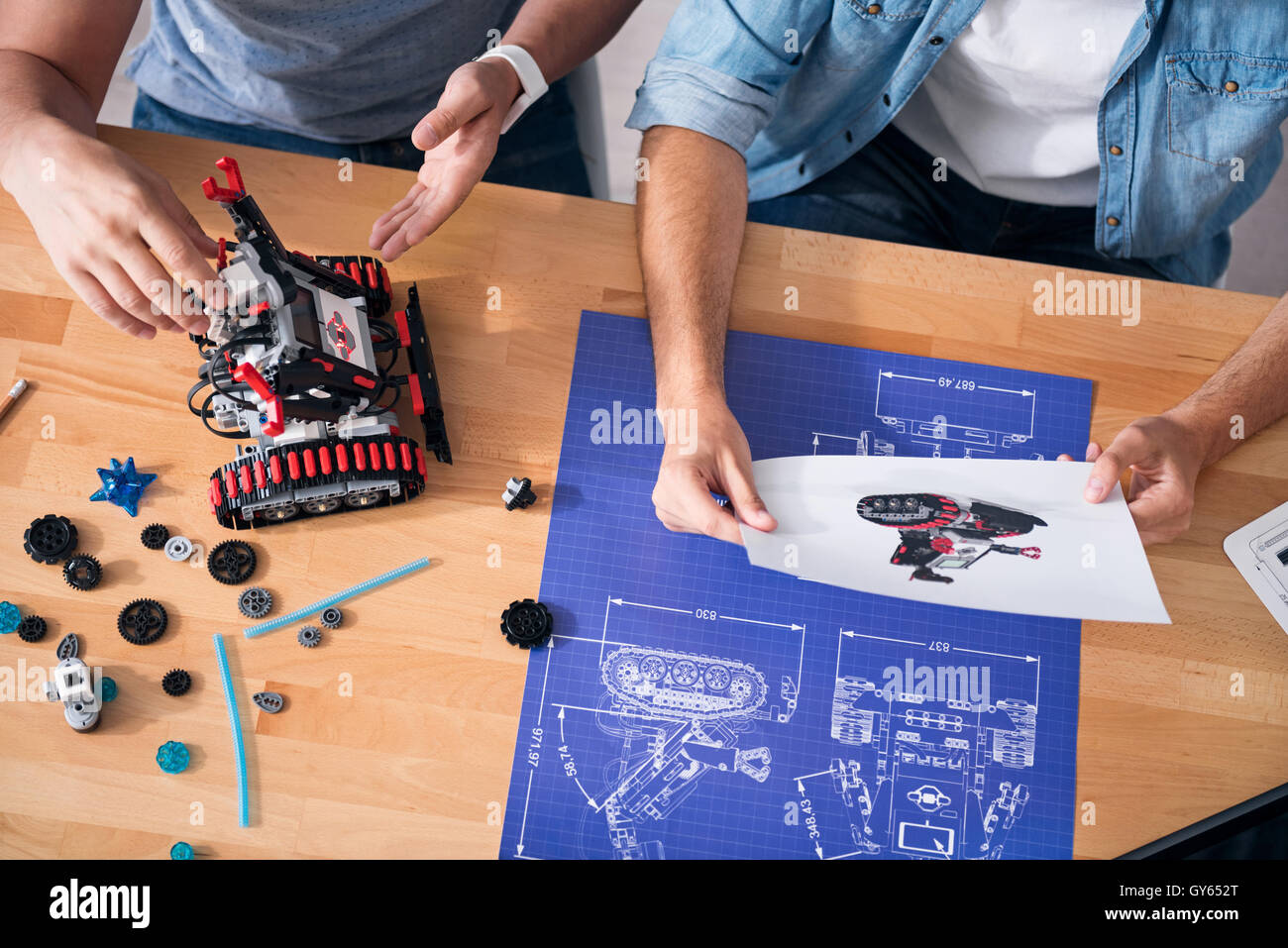 Professional engineers constructing robot Stock Photo - Alamy