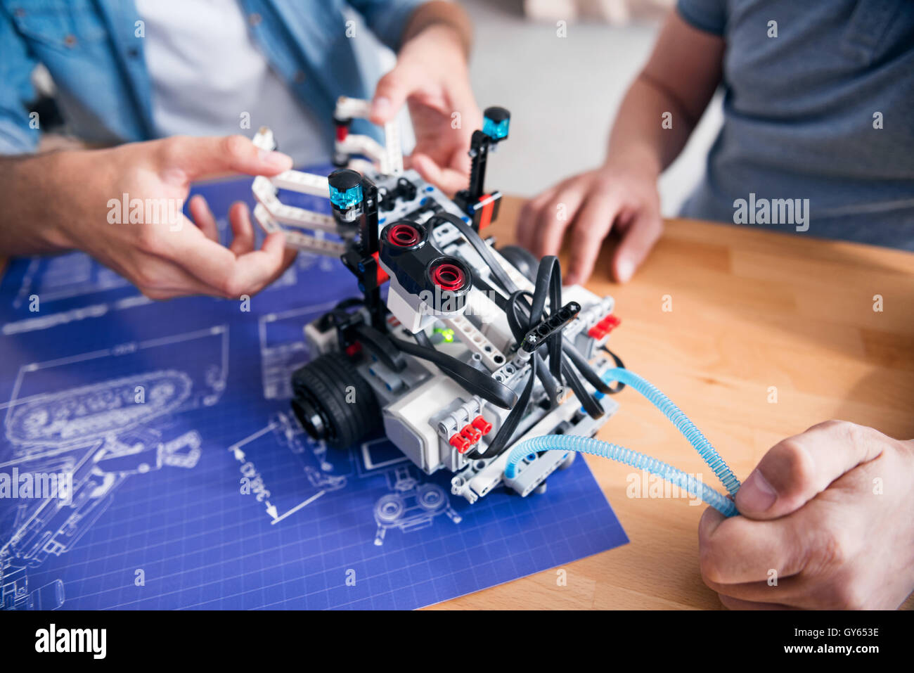 Professional engineers constructing robot Stock Photo - Alamy