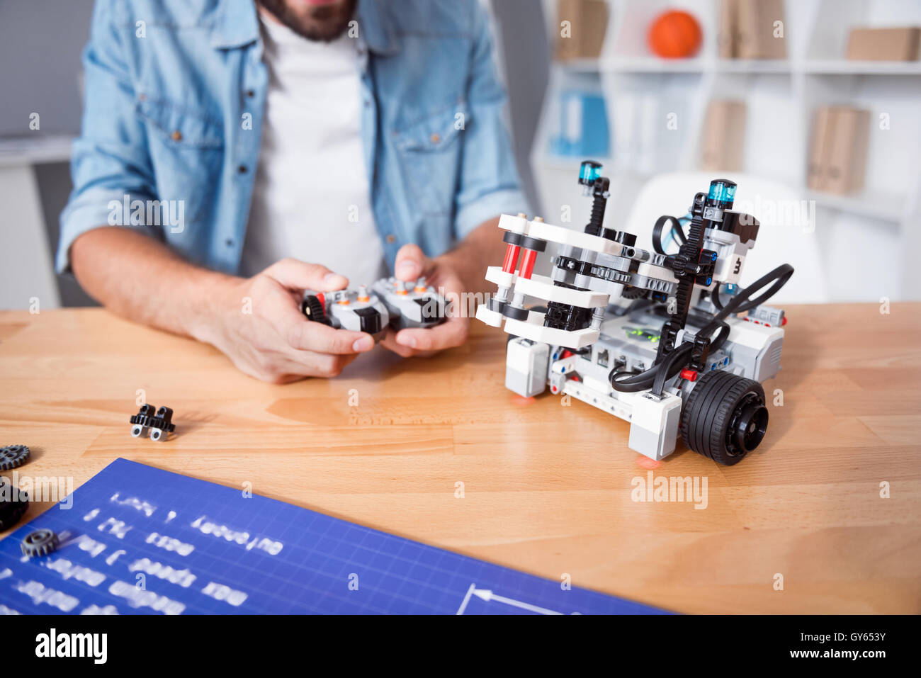 Pleasant professional man testing robot Stock Photo - Alamy