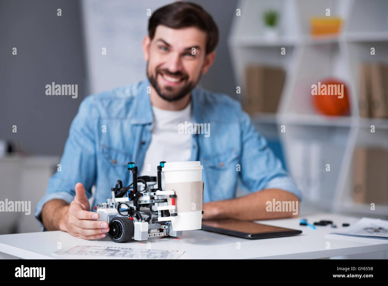 Positive man testing robot Stock Photo - Alamy