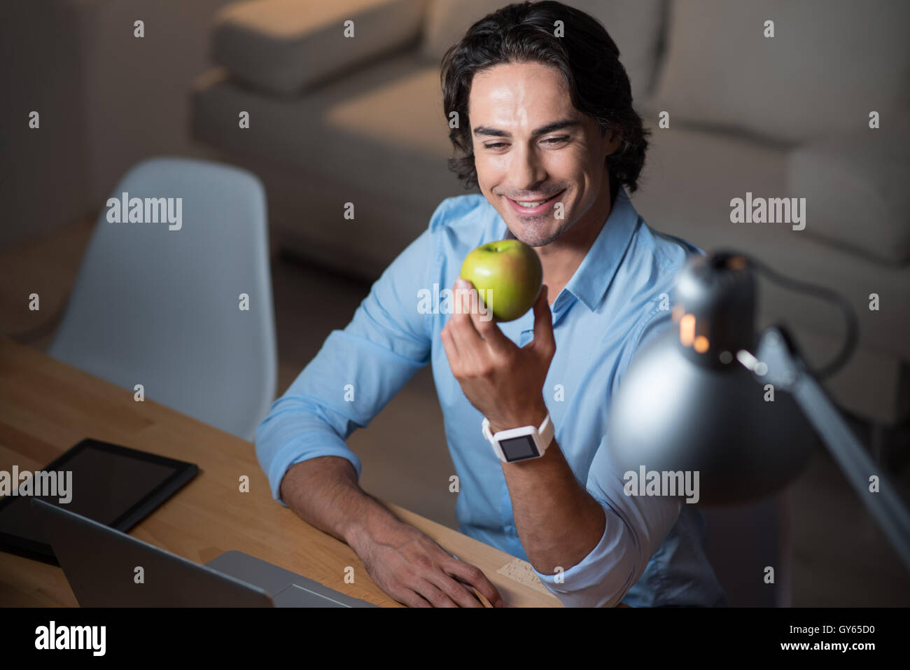 Young smiling man examine an apple Stock Photo - Alamy