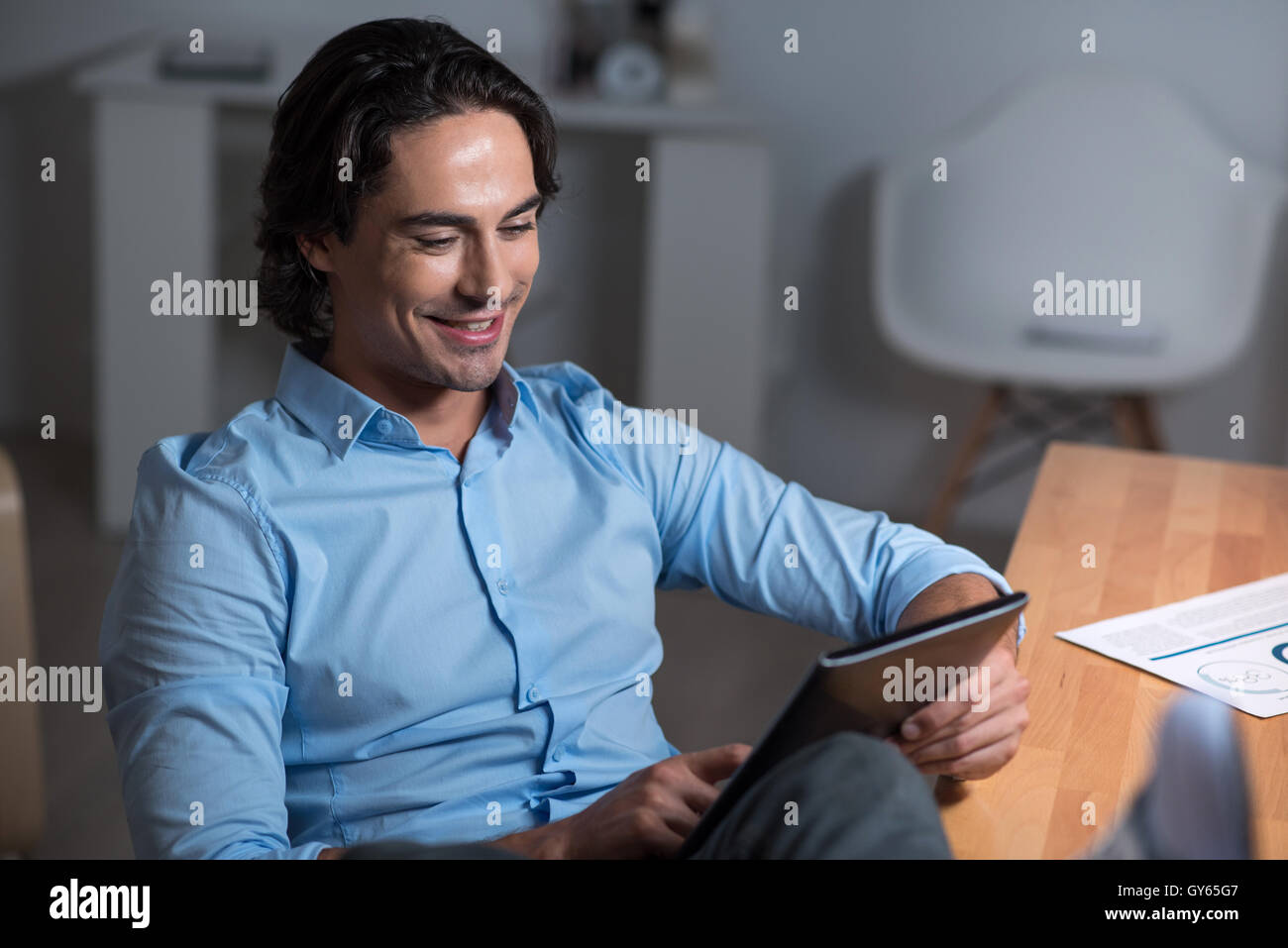 Handsome young content man using laptop Stock Photo - Alamy