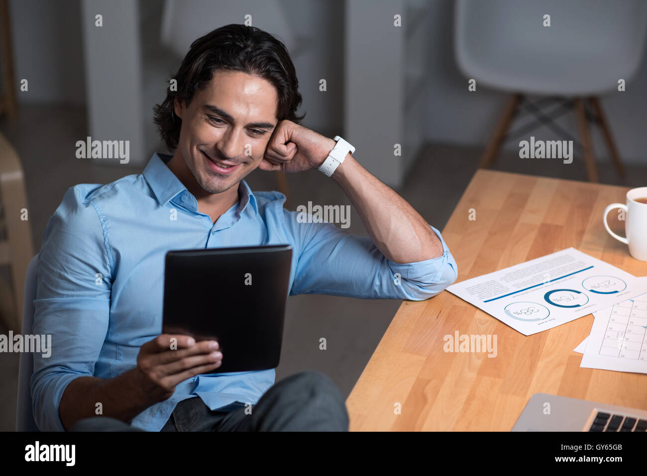 Handsome young involved man using laptop Stock Photo - Alamy