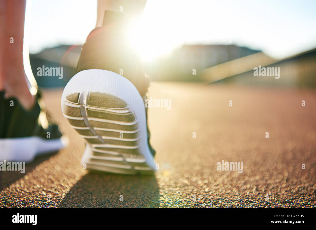 Close up low angle view of running shoes with while soles on an empty ...