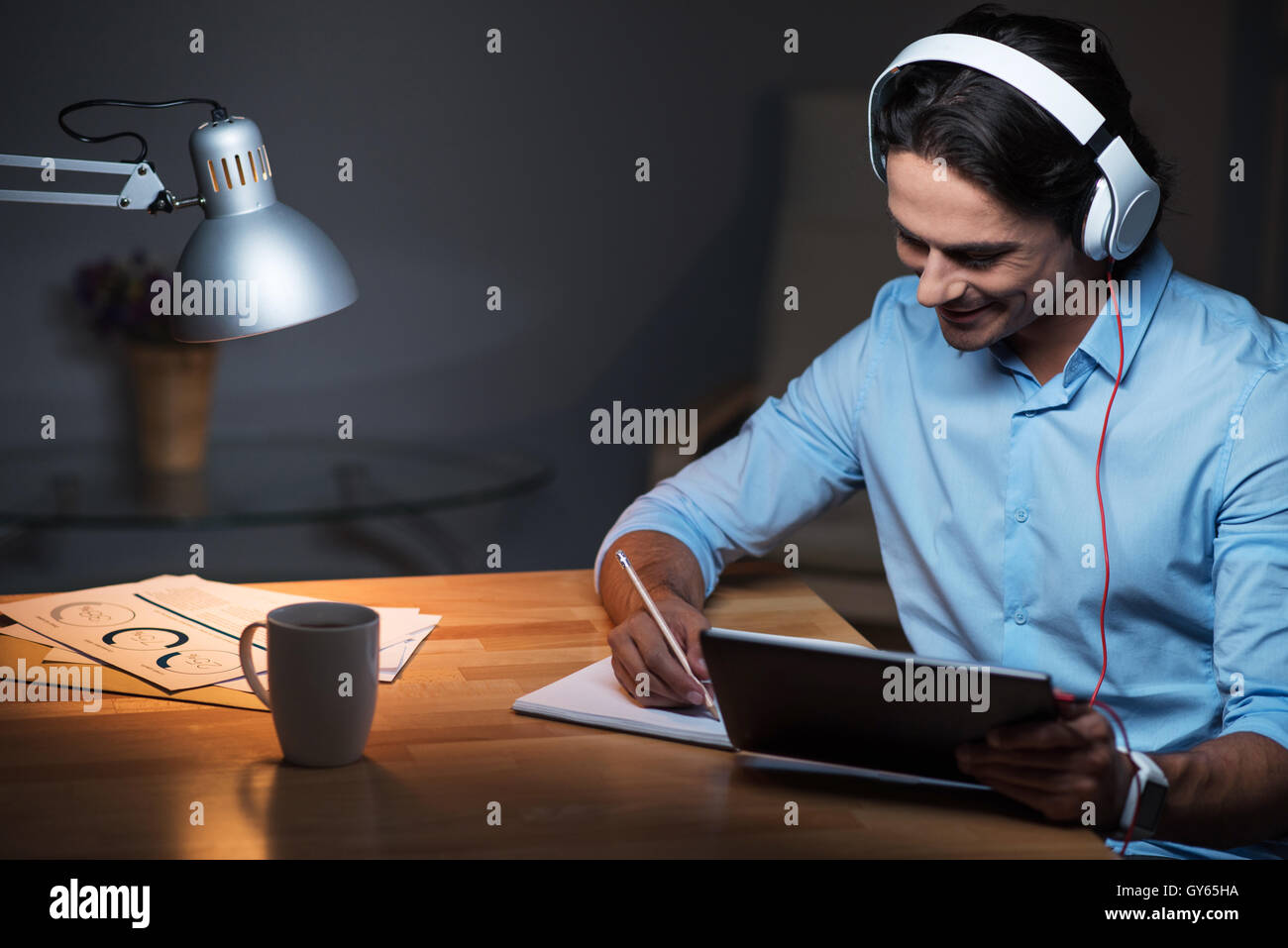Happy young man making notes Stock Photo - Alamy