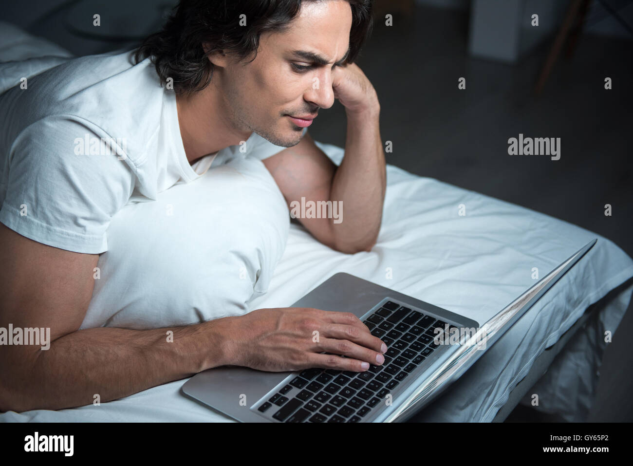 Concentrated man using laptop Stock Photo - Alamy