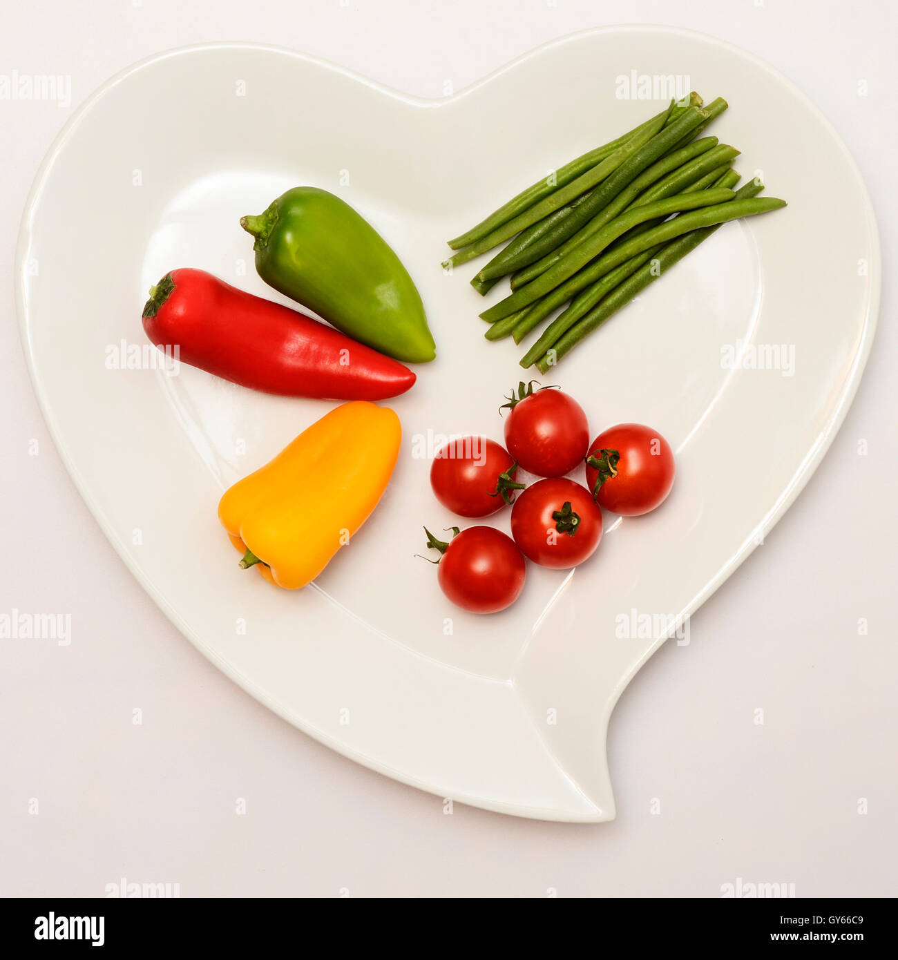 Heart shaped plate and vegetables, healthy food Stock Photo - Alamy