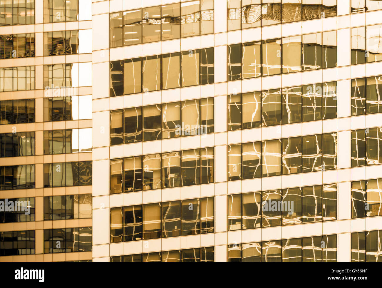 Close-up of the glass office building with reflections and sepia effect ...