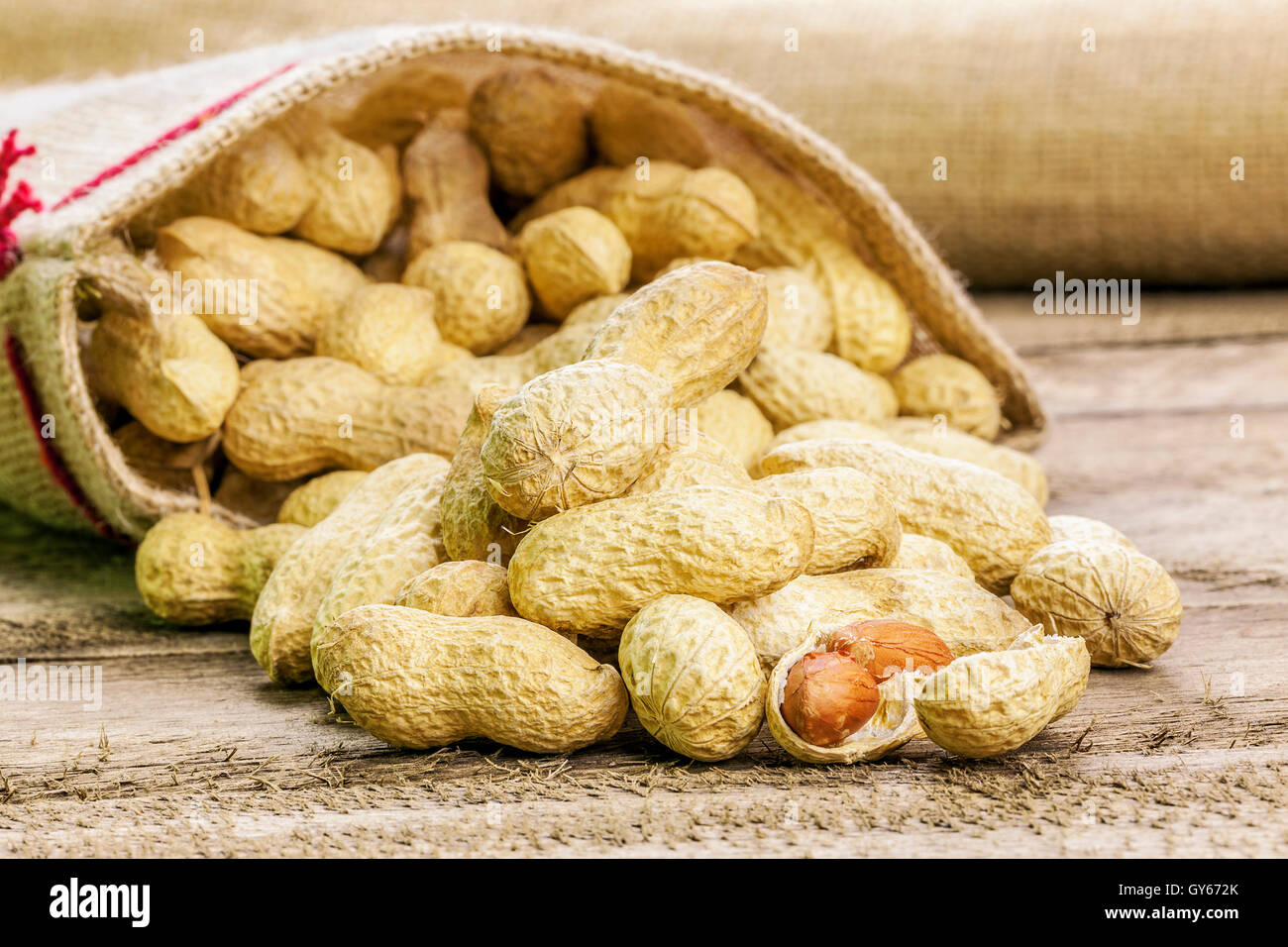 Peanuts in shell on jute fabric bag Stock Photo - Alamy