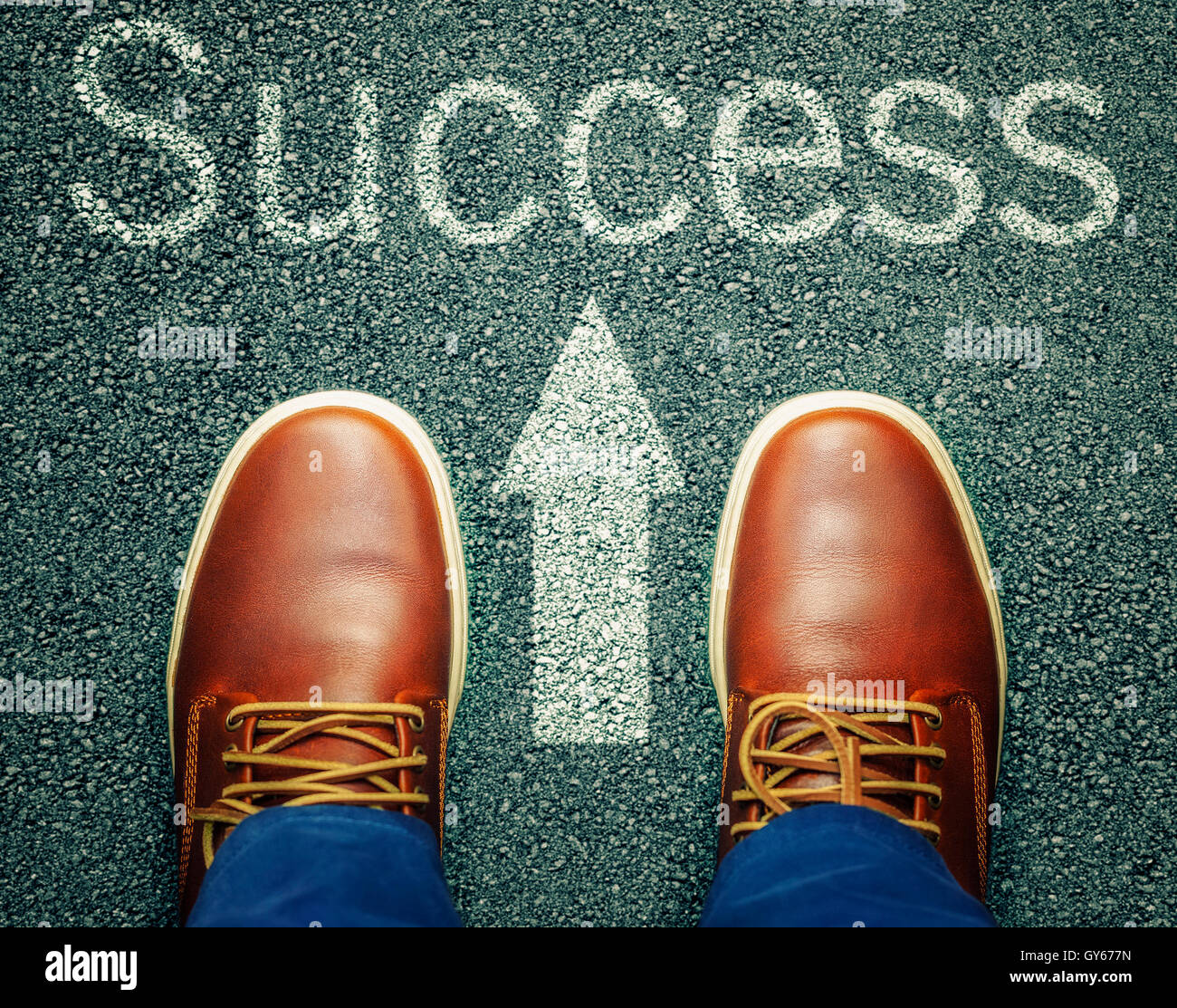 Man before message Success on asphalt Stock Photo - Alamy