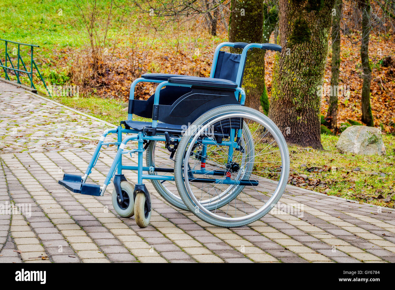 The wheelchair in the park path Stock Photo - Alamy
