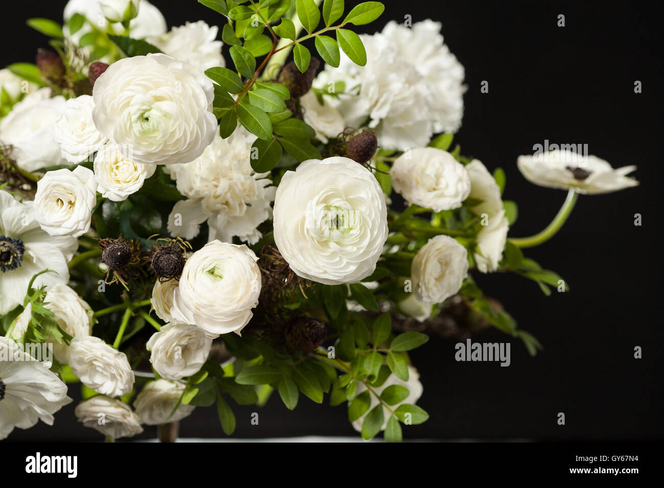 Flower composition on a black background Stock Photo - Alamy