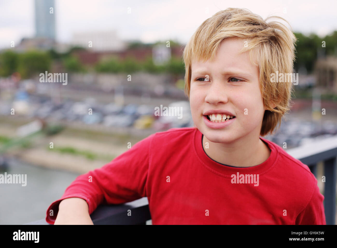 Portrait of cute 8 years old boy standing on the brige Stock Photo - Alamy