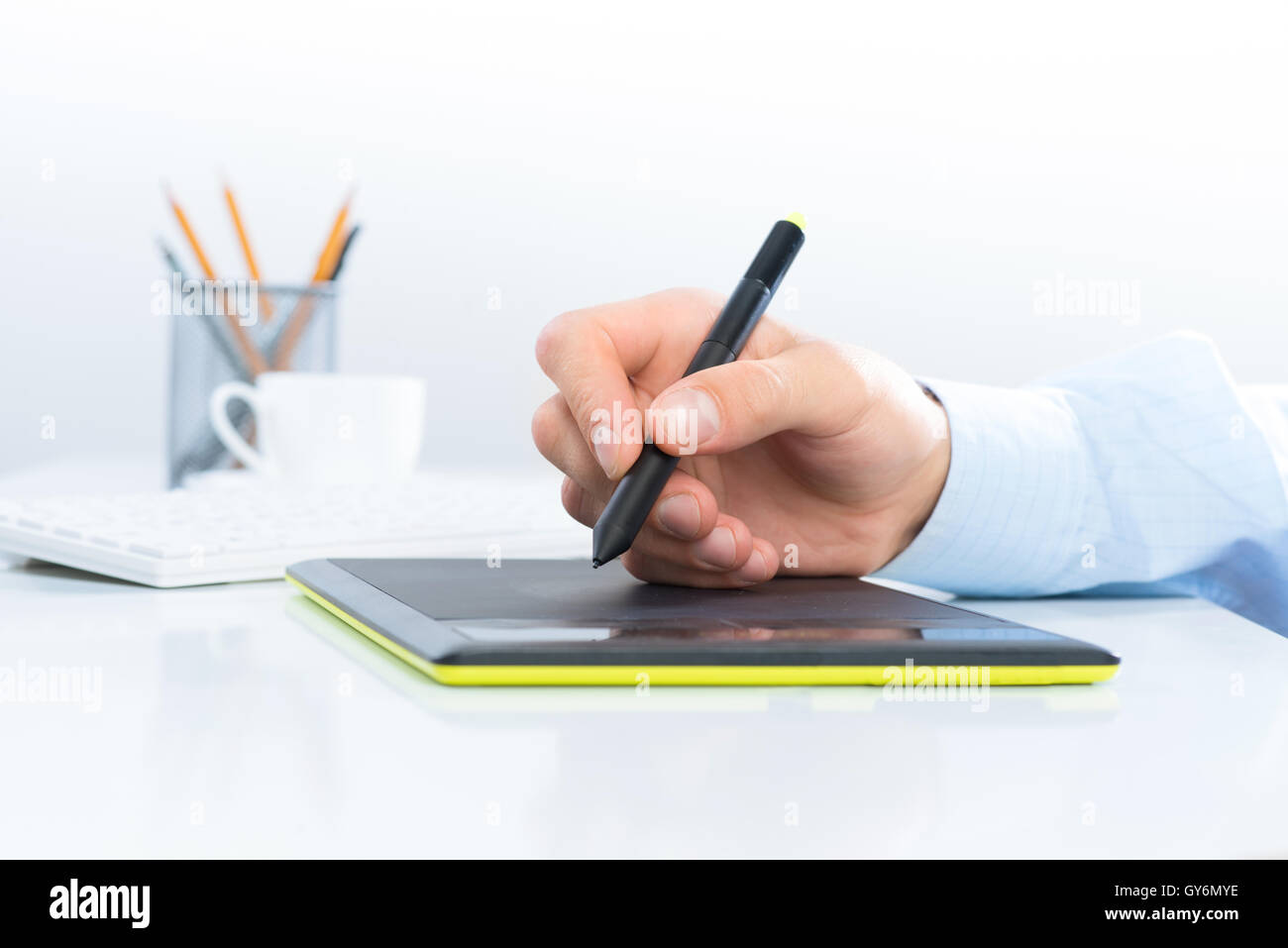 Designer hand drawing a graph on the tablet Stock Photo - Alamy