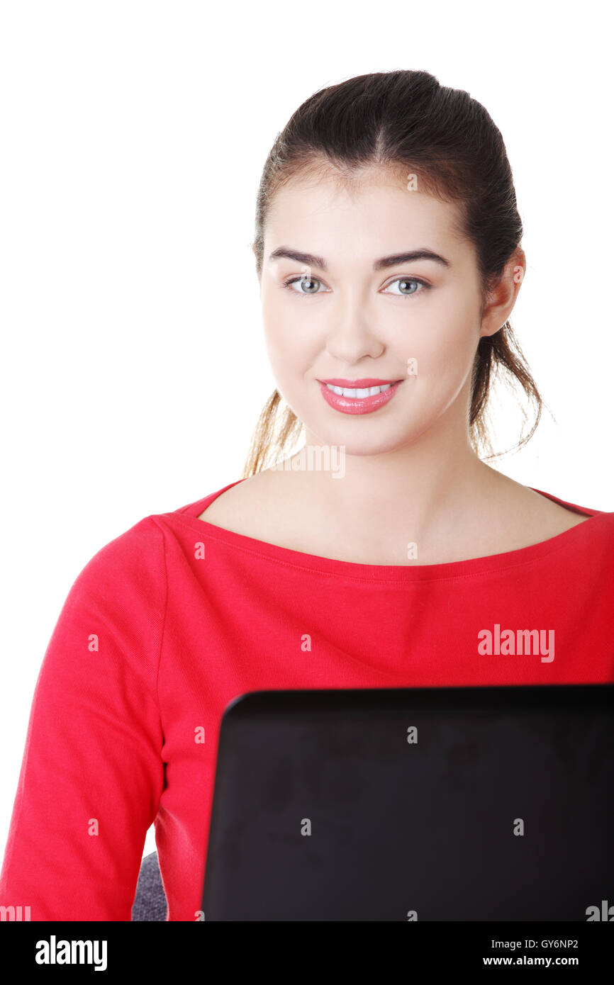 Happy casual woman sitting in front of computer Stock Photo - Alamy