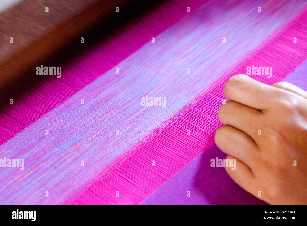 Weaving cloth on a loom in Java Indonesia Stock Photo - Alamy