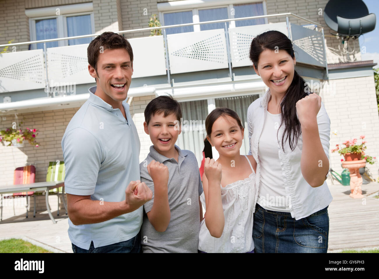 Excited family celebrating success Stock Photo - Alamy