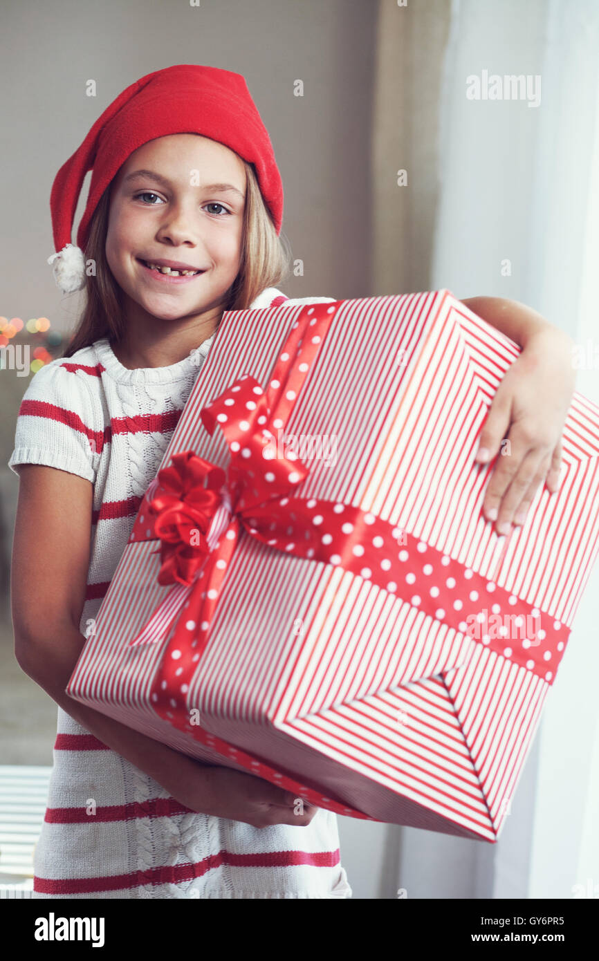Child holding big gift Stock Photo - Alamy