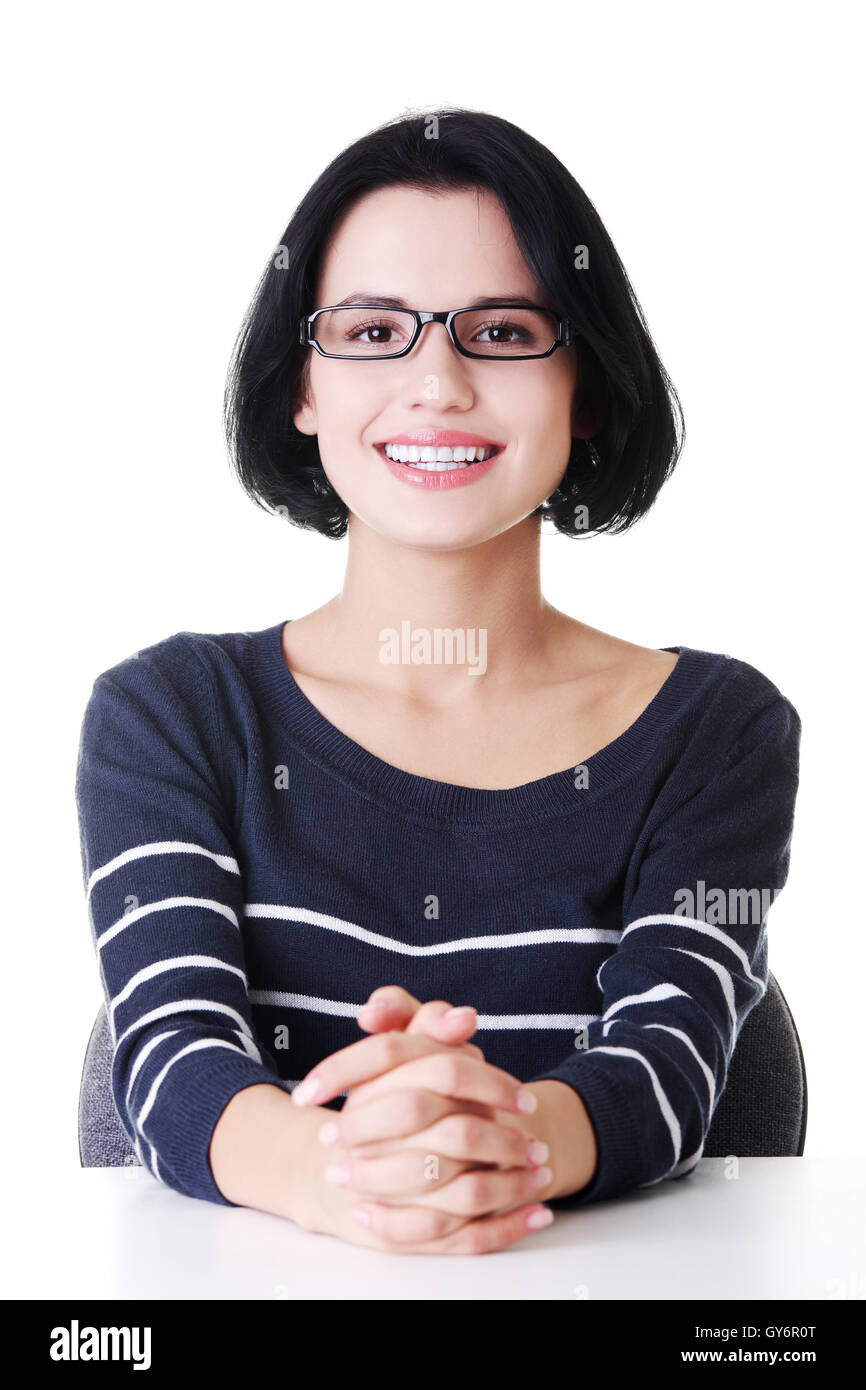 Attractive woman's portrait sitting by a table Stock Photo - Alamy