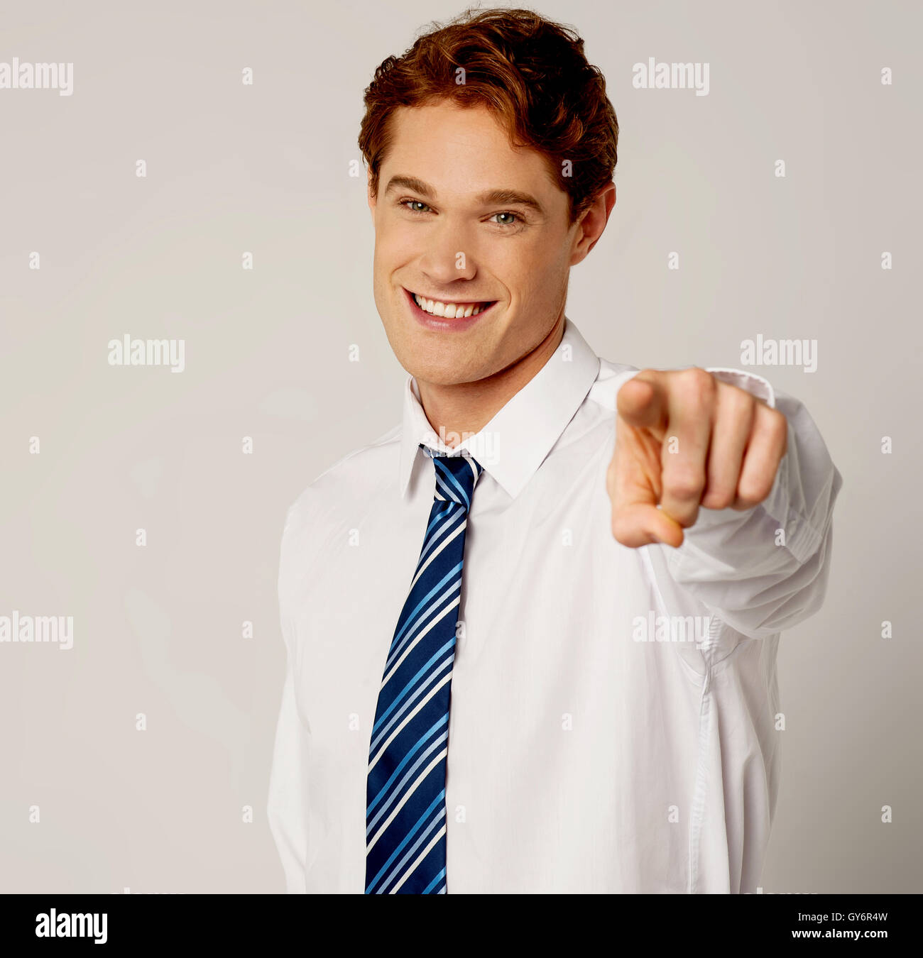Young smiling businessman pointing you out Stock Photo - Alamy