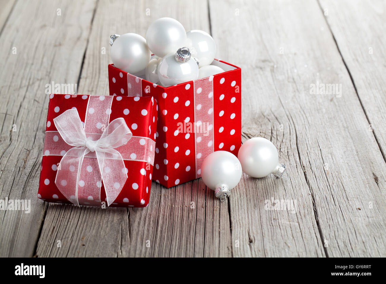 red gift box, polka dots with, on wood background Stock Photo - Alamy