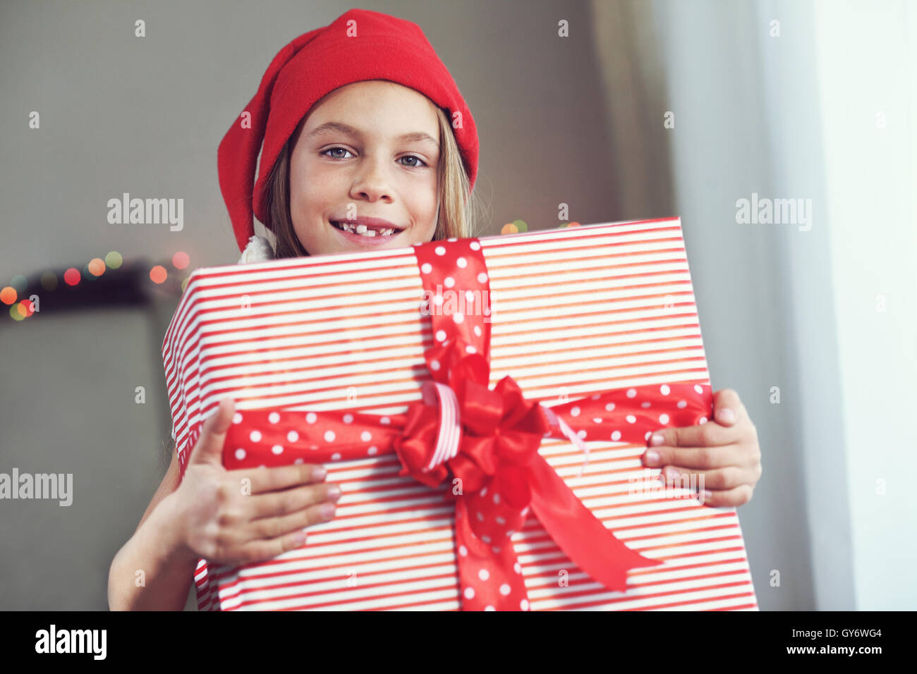 Child holding big gift Stock Photo - Alamy