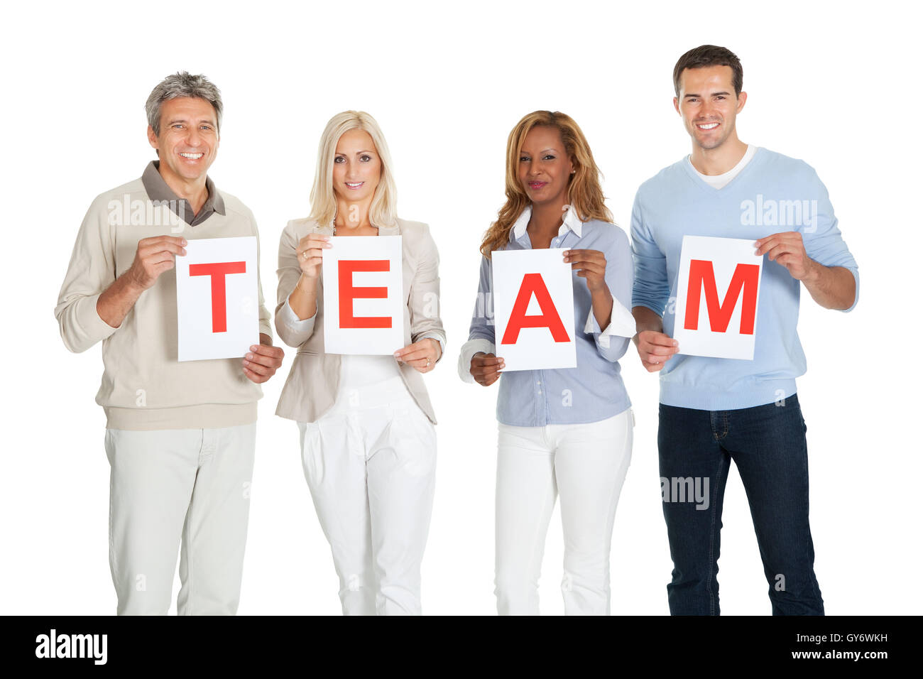 Happy group of people holding team sign board Stock Photo - Alamy