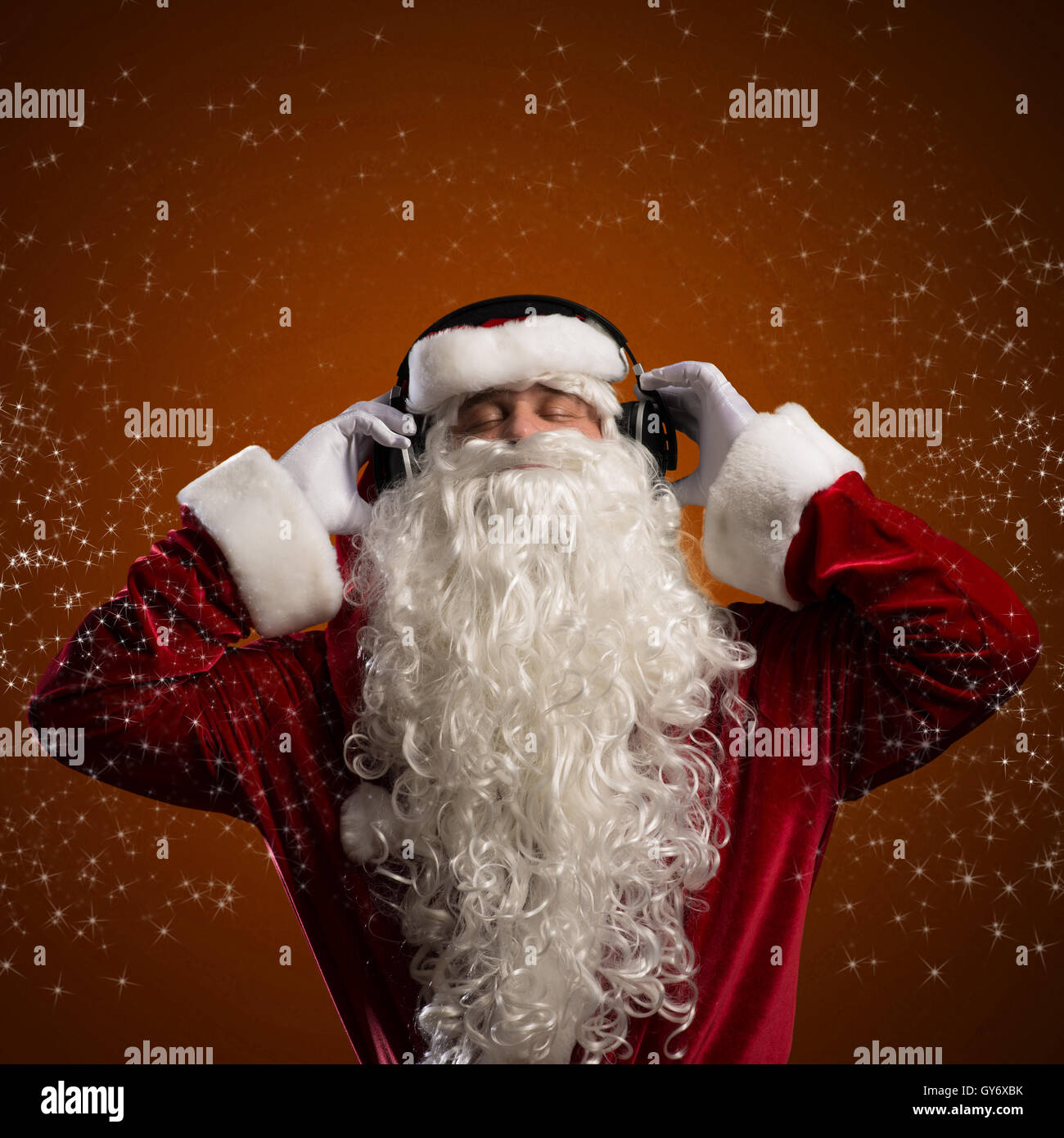 Santa Claus is listening to music Stock Photo - Alamy