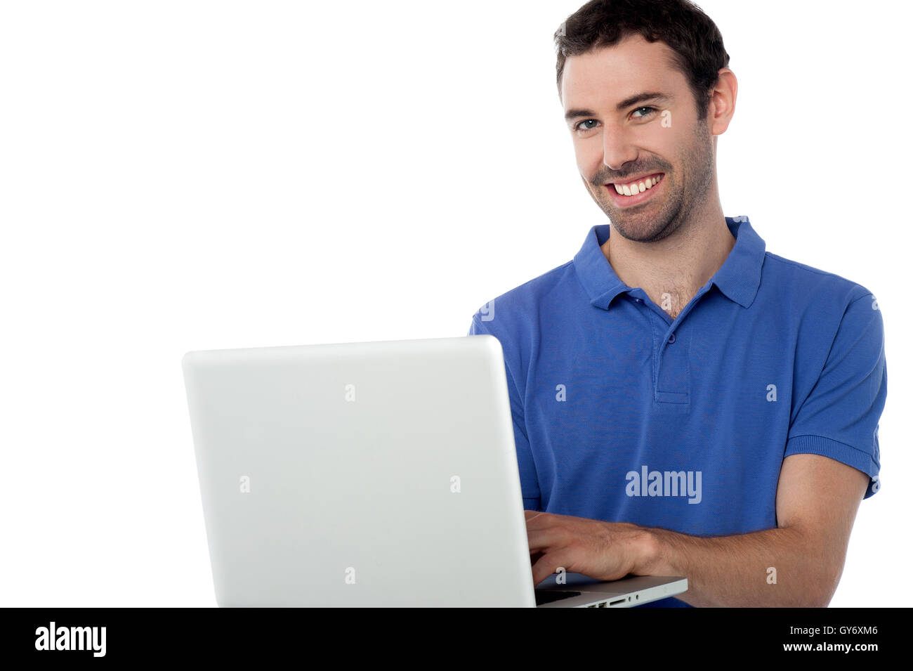 Smart smiling guy working on laptop Stock Photo - Alamy